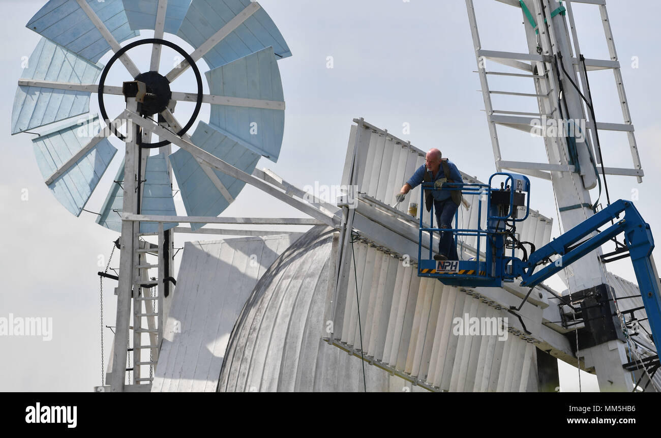 Dan Carrick paints the shutters on Wicken Village windmill in ...