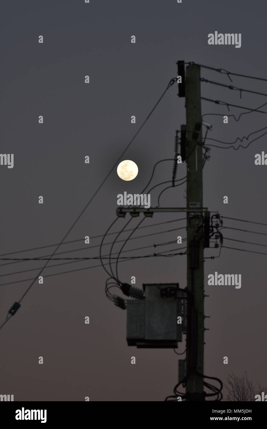 view of the moon adjacent to power pole with transformer Stock Photo ...