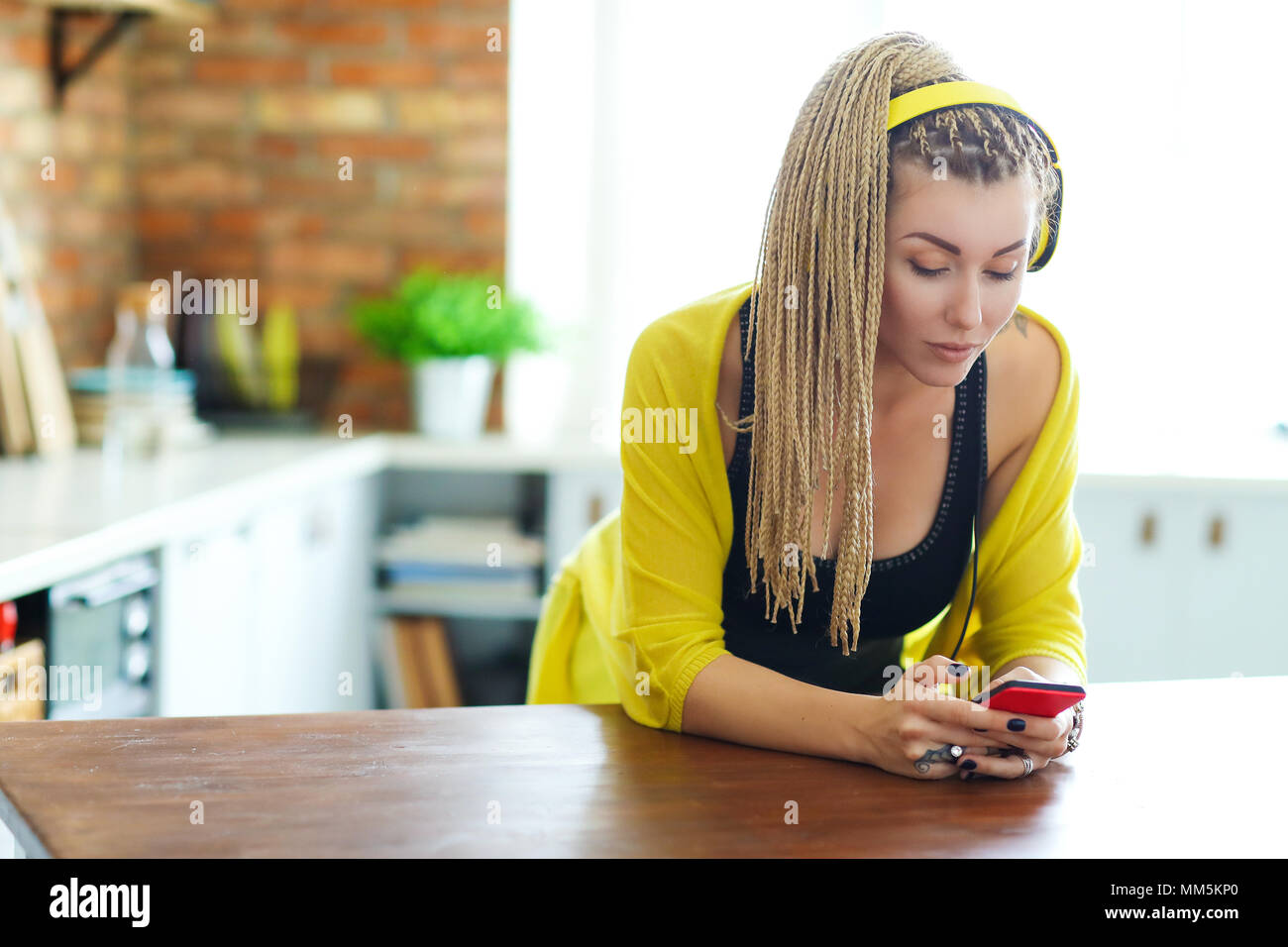 Hairstyle and fashion. Woman with yellow dreadlocks Stock Photo - Alamy