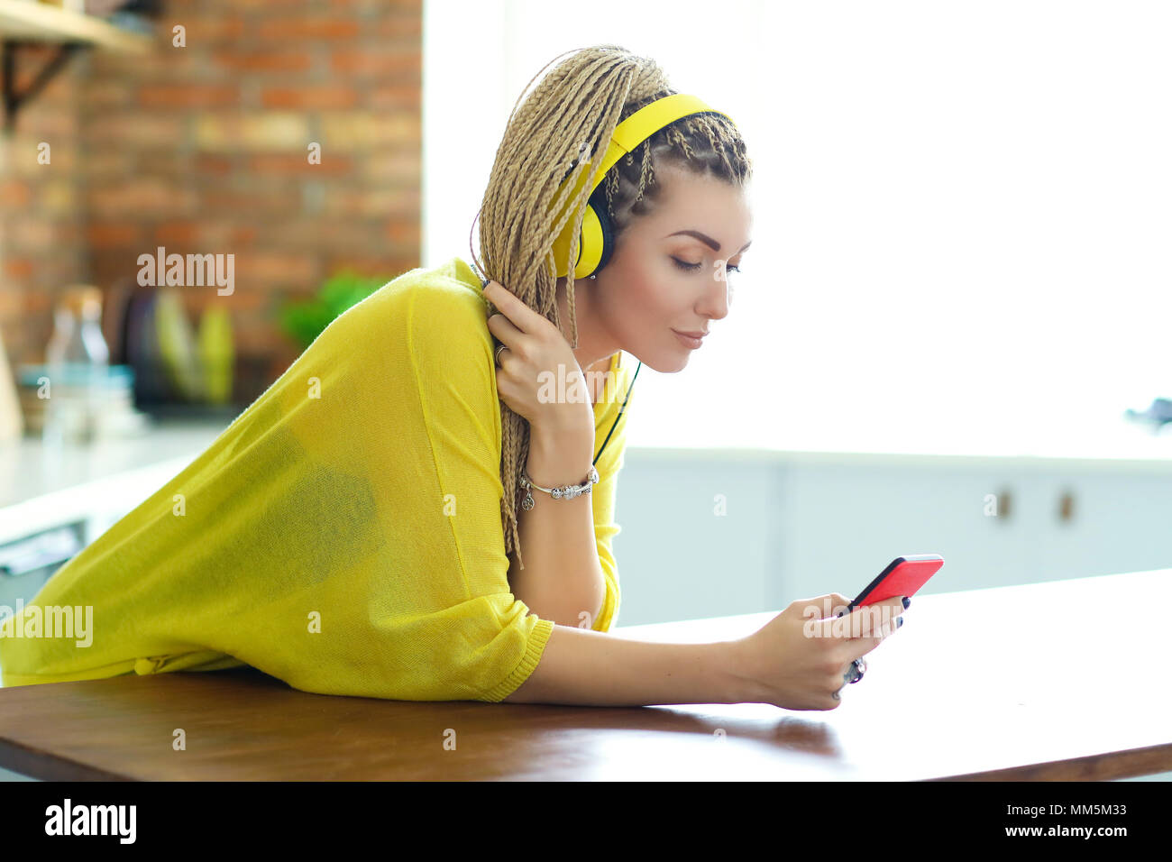 Hairstyle and fashion. Woman with yellow dreadlocks Stock Photo - Alamy
