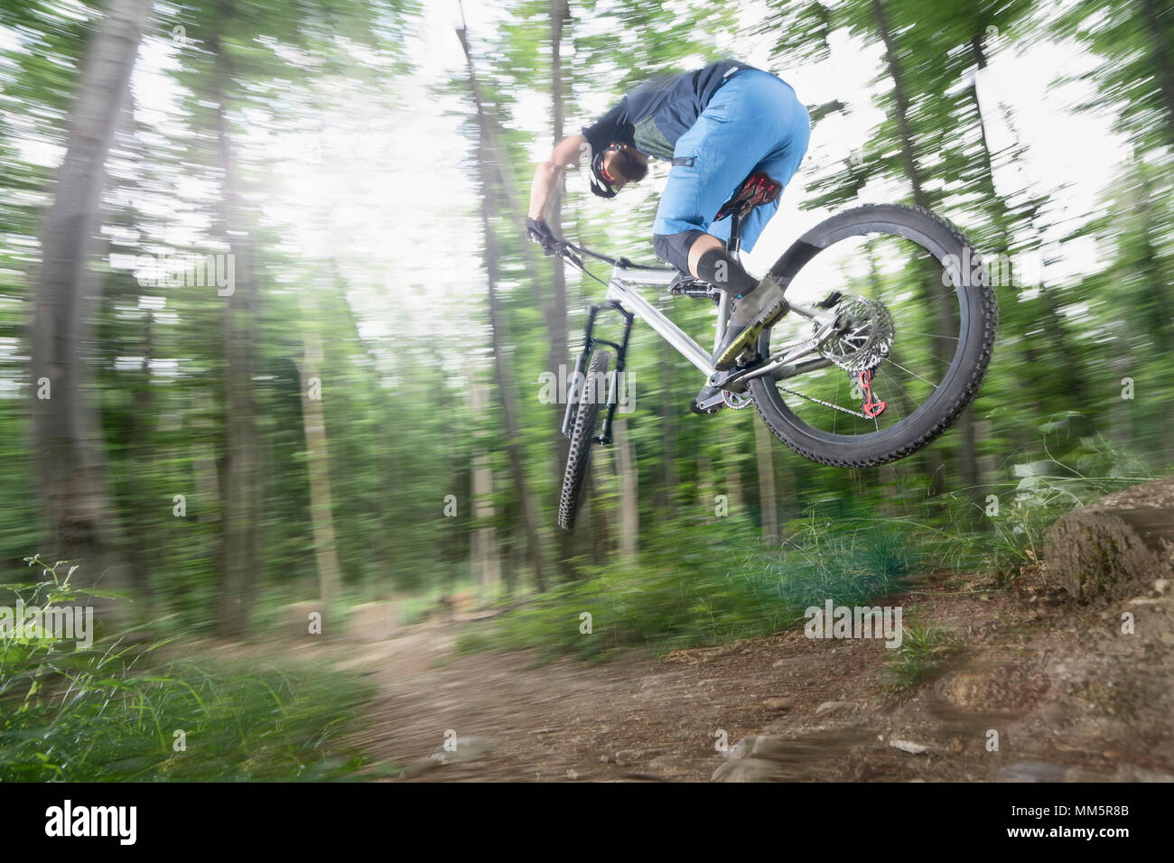 Biker mid jump forest hi-res stock photography and images - Alamy