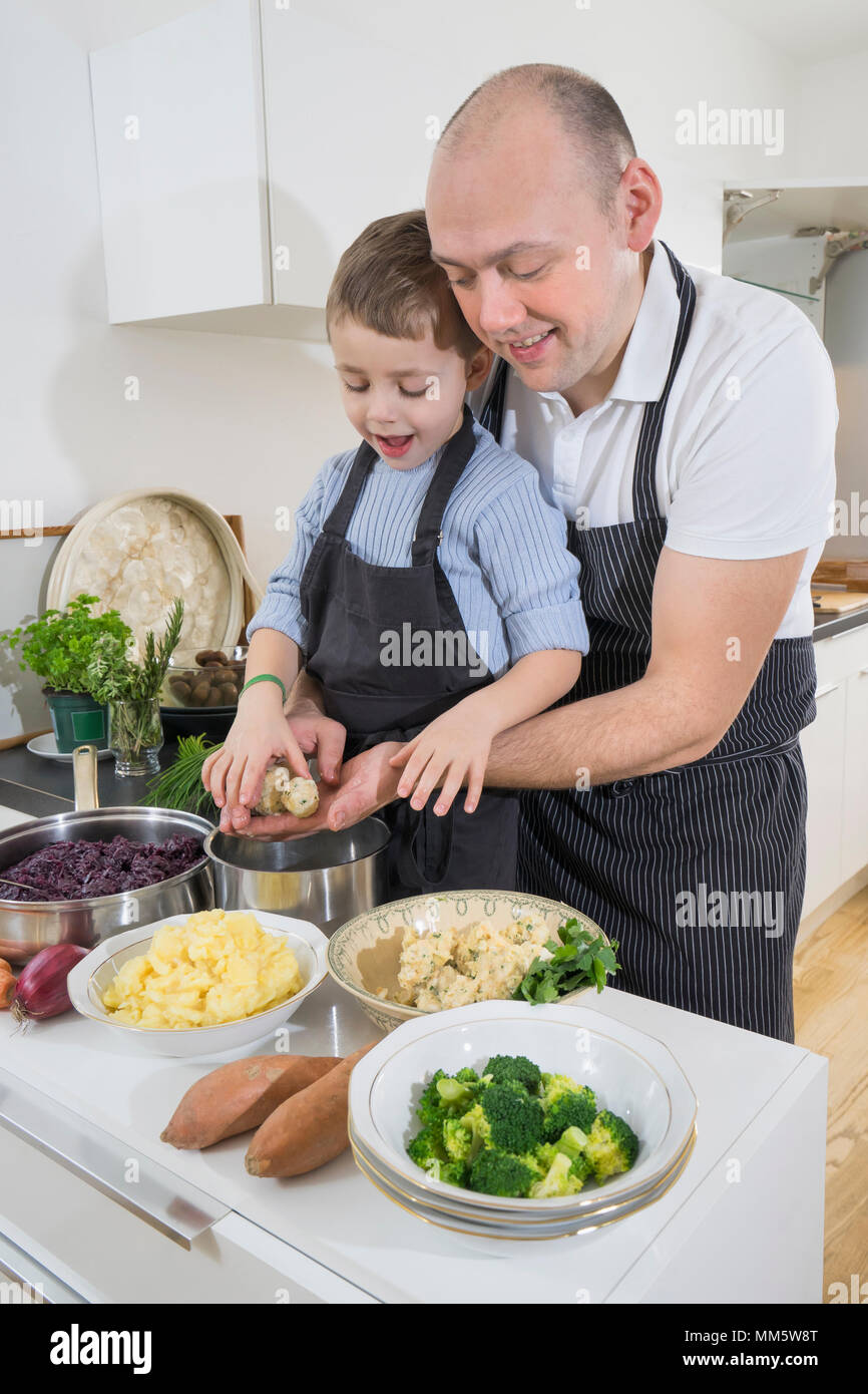 Father and son preparing dumplings in kitchen Stock Photo - Alamy