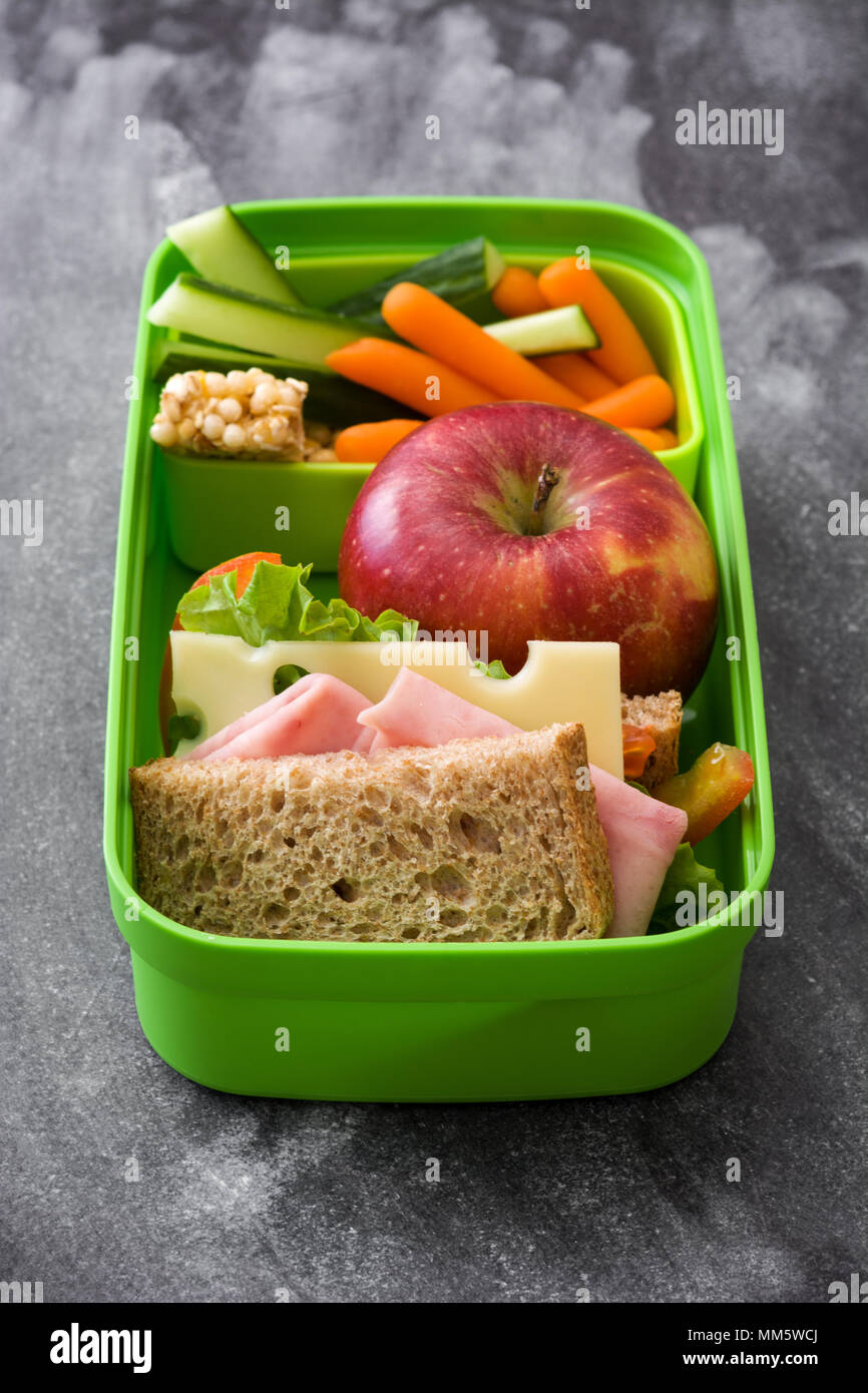 Healthy school lunch box: Sandwich, vegetables ,fruit and juice on ...
