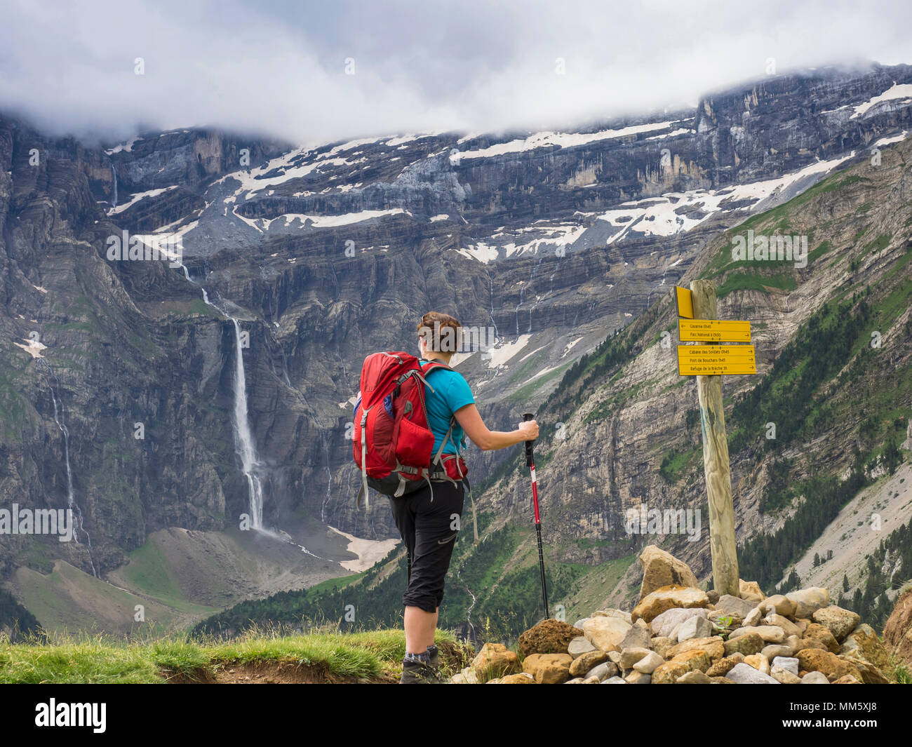 Woman hiking in the High Pyrenees with view over Cirque de Gavarnie ...