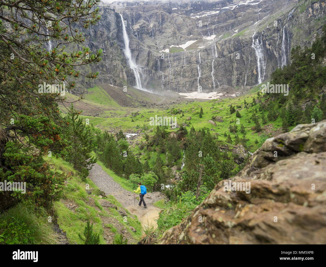 Woman hiking in the High Pyrenees with view over Cirque de Gavarnie ...