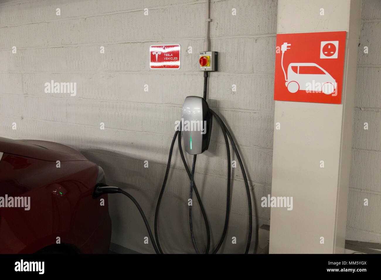 Tesla electric car charging inside the underground multi storey / level ...