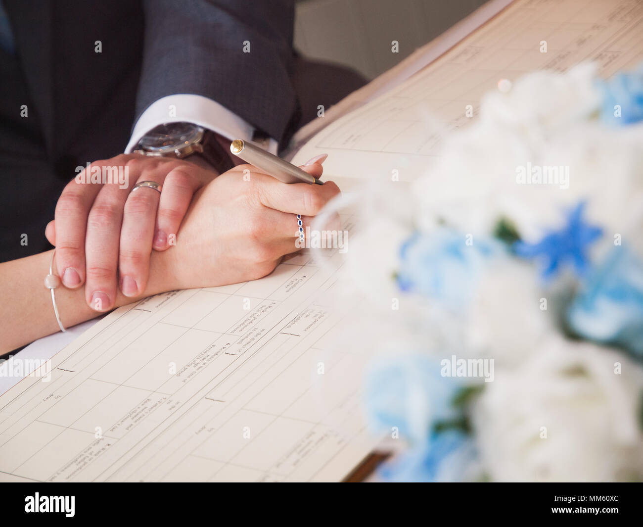 Young couple signing wedding register documents. Focus on hand Stock ...