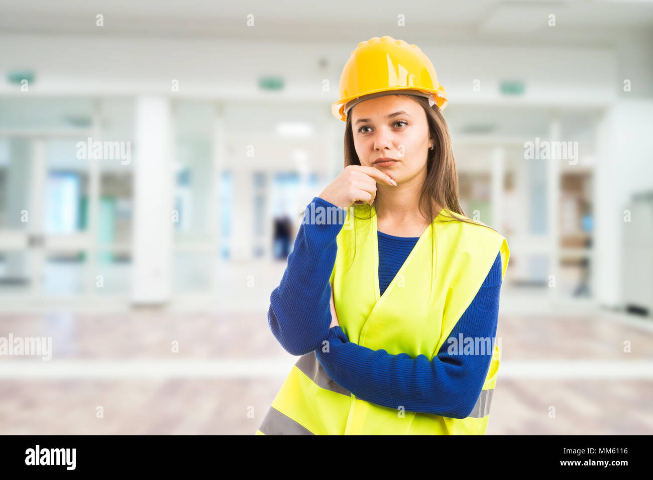 Young attractive female engineer thinking as pensive meditating for ...