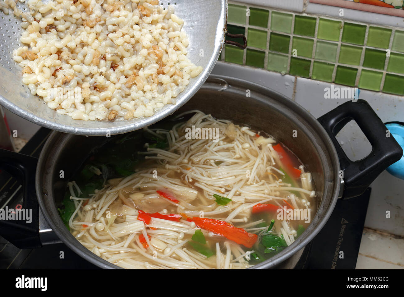 In picture is cooking. It's mushroom curry with ant larvae. Curry has ...