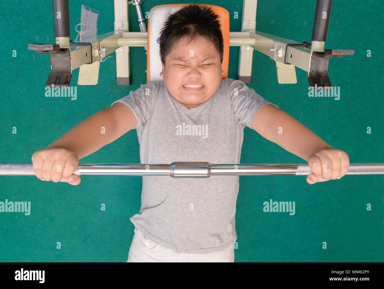 Obese fat boy weightlifting in fitness room,Exercise to lose weight ...