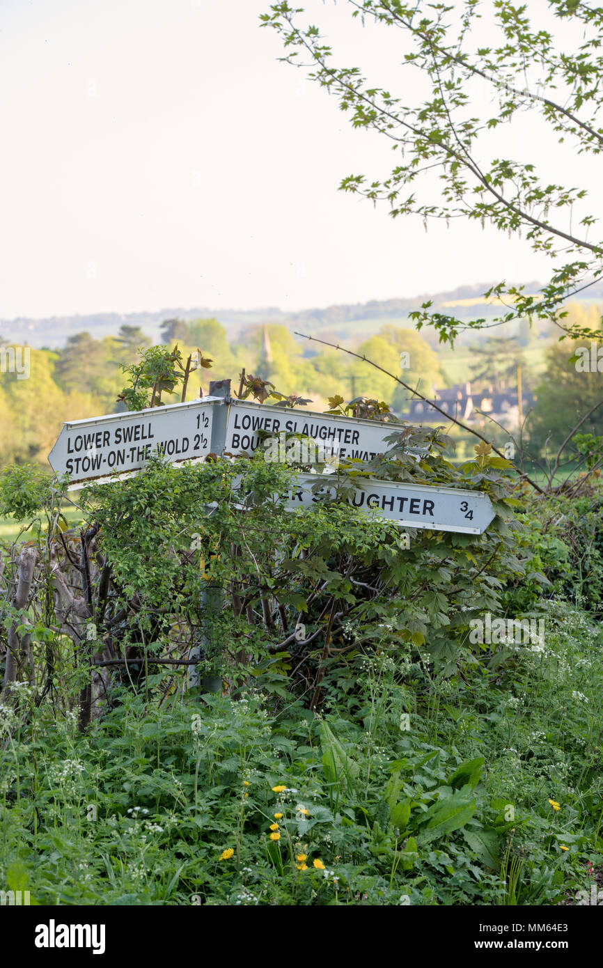 Upper and Lower Slaughter signpost in spring. Cotswolds ...