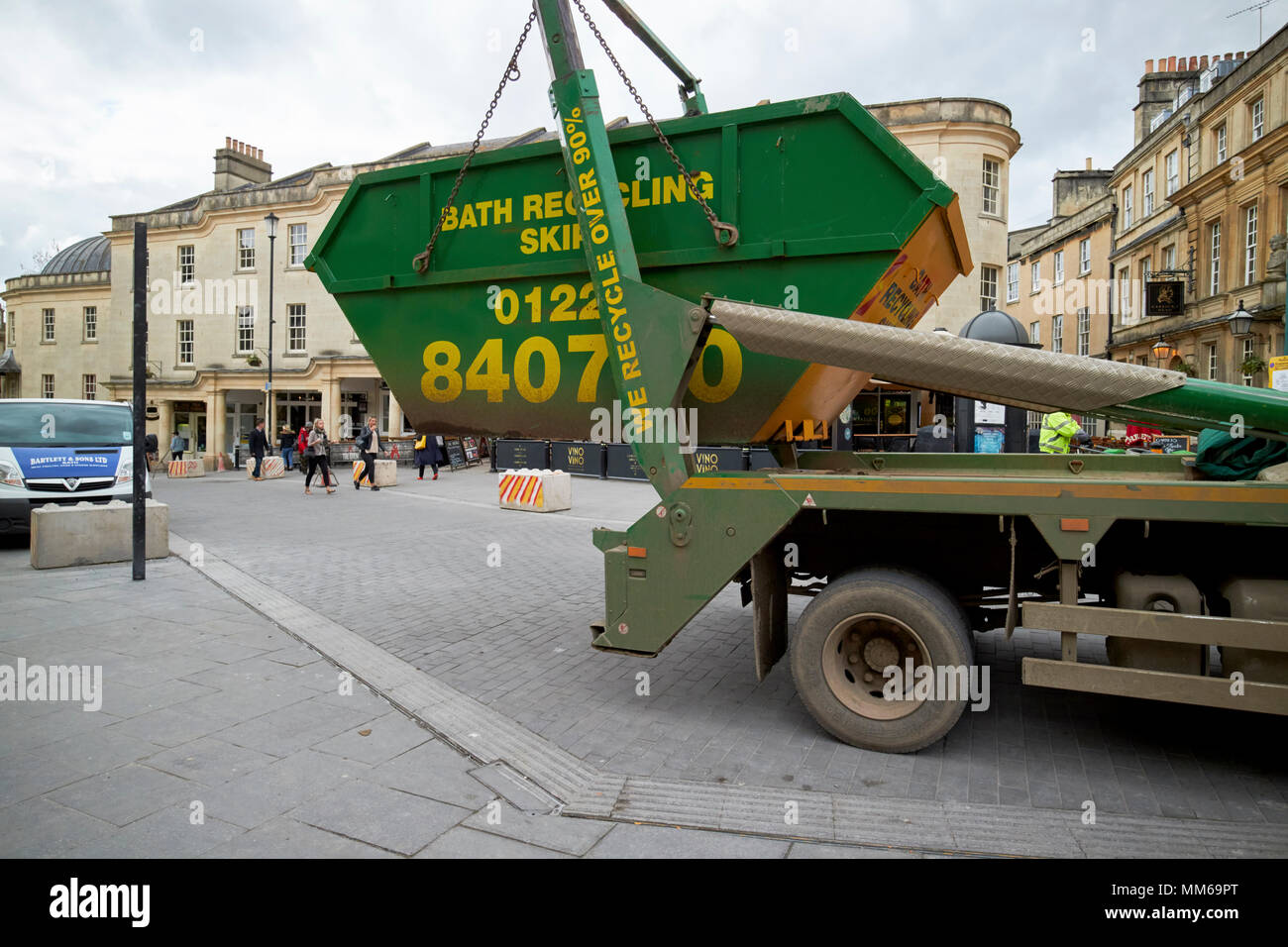 recycling skip being delivered by lorry in the city centre of Bath ...