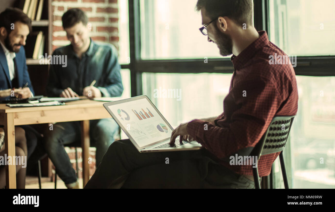 commercial Director working with financial graphs on the laptop Stock ...