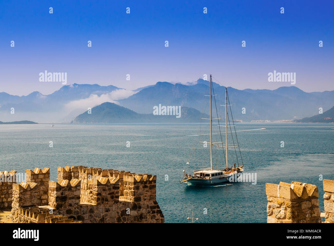 Scenic view of the sea with sailing ship from the walls of medieval ...