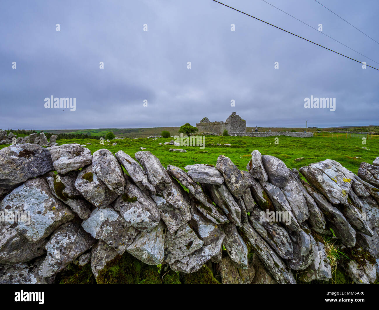 Stone wall and ancient church ruin in Ireland Stock Photo - Alamy