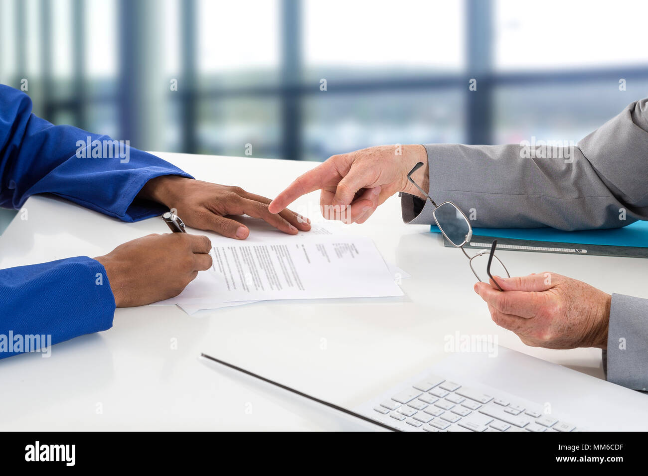 African man signing paper hi-res stock photography and images - Alamy
