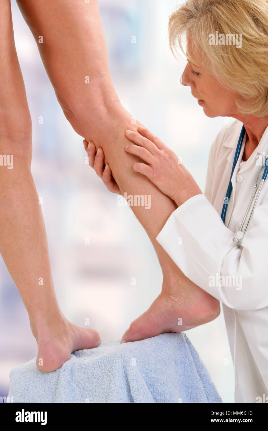 Doctor examining legs female patient hi-res stock photography and ...