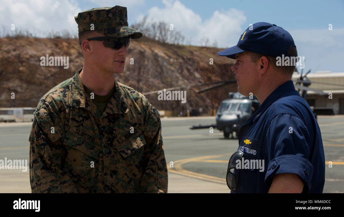 U.S. Coast Guard Capt. Robert Warren, right, a liaison officer with ...