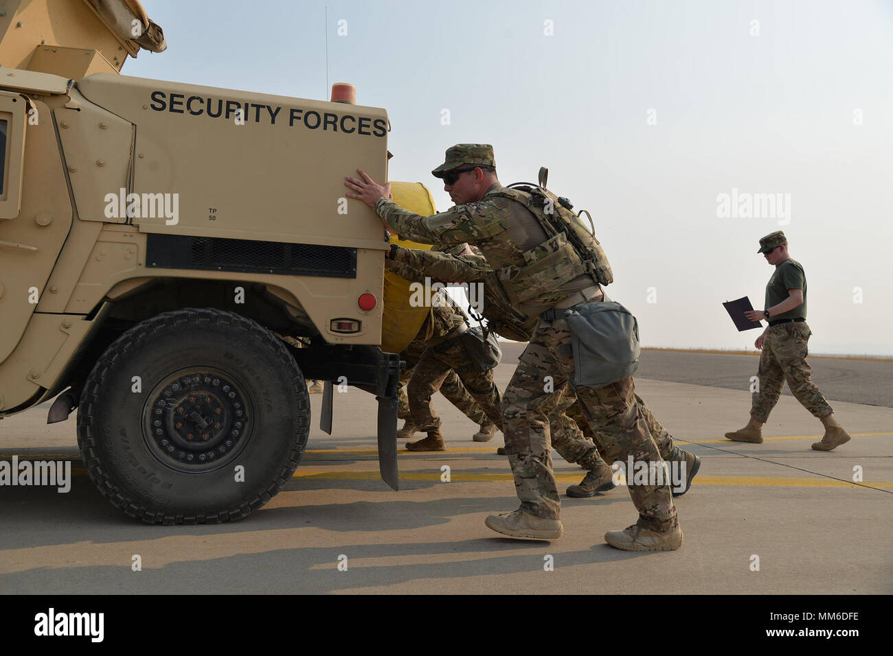 A team of security forces Airmen push a Humvee during the annual Aces ...