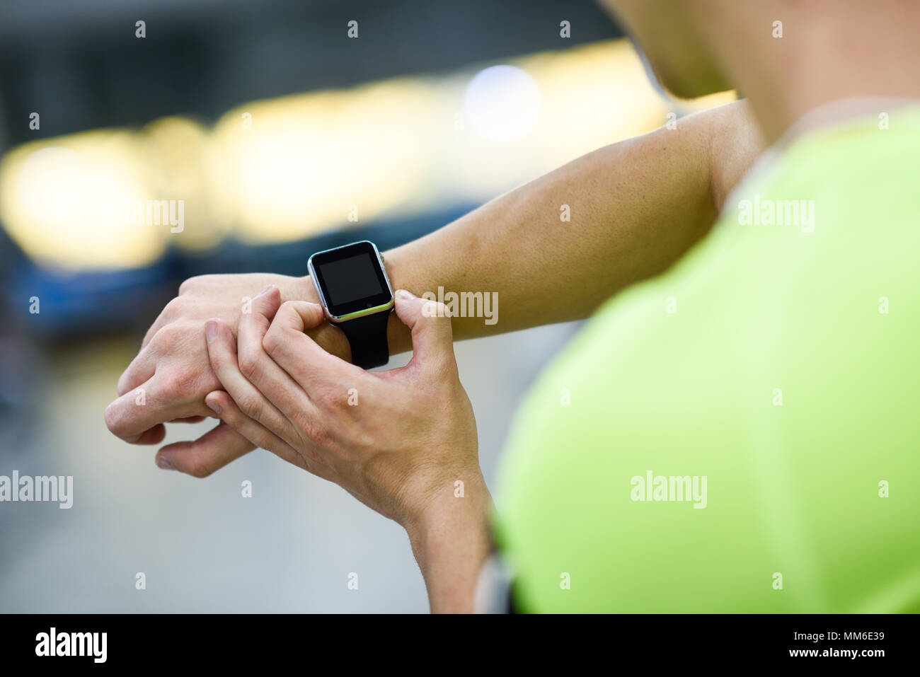 Young man using smartwatch at the gym. Caucasian male working out Stock ...