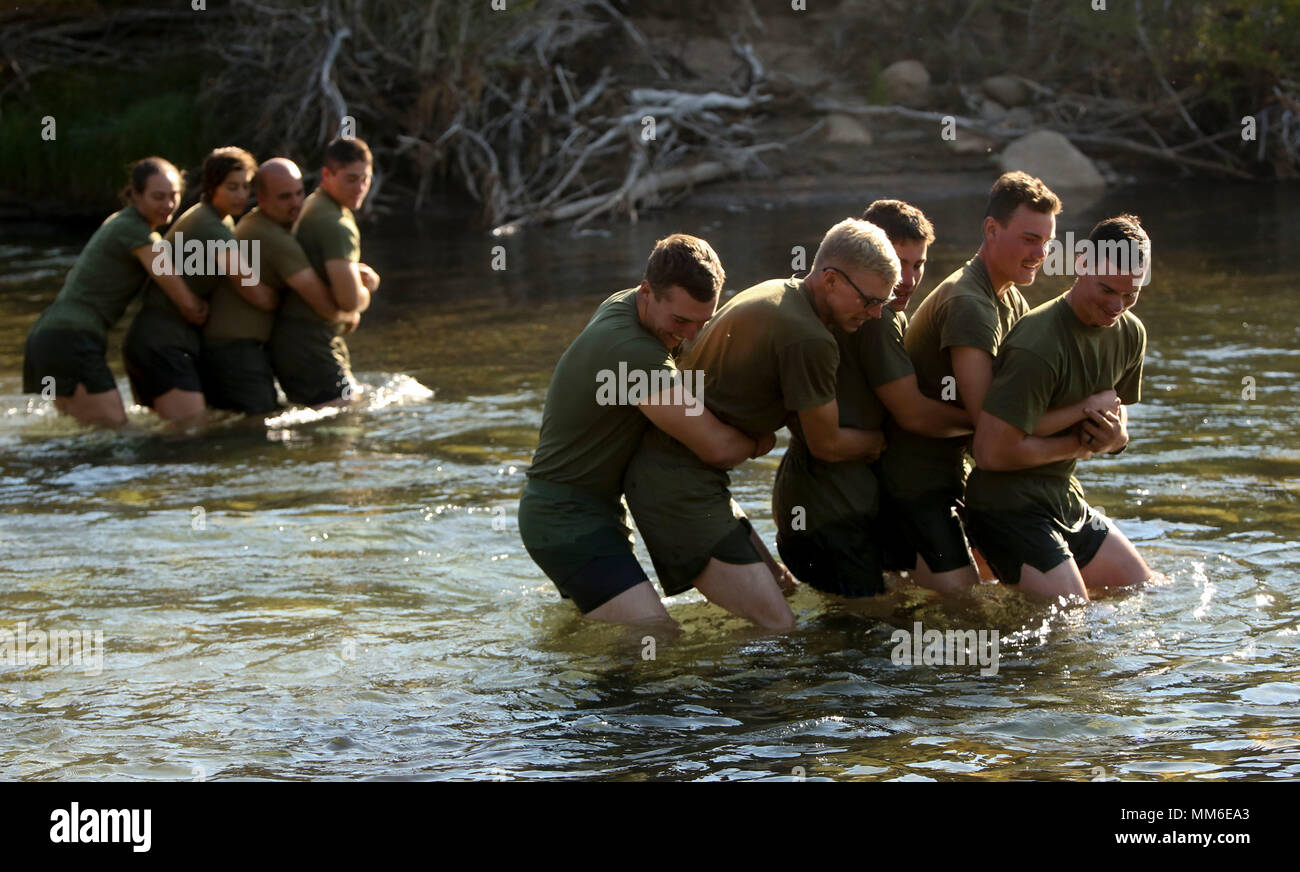 Marines work together to move through strong currents during a stream ...