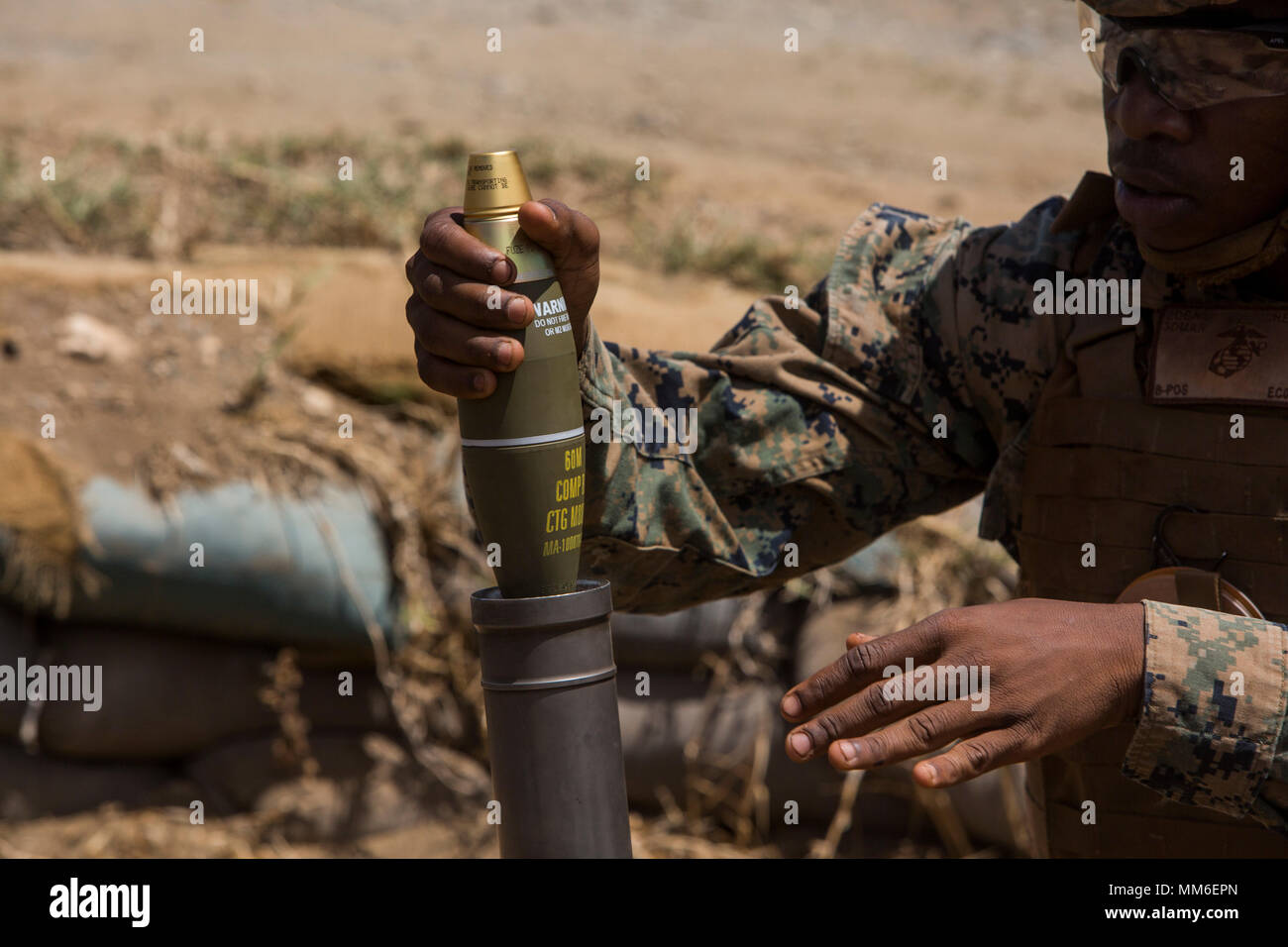 A mortarman with Echo Company, 2nd Battalion, 3rd Marine Regiment ...