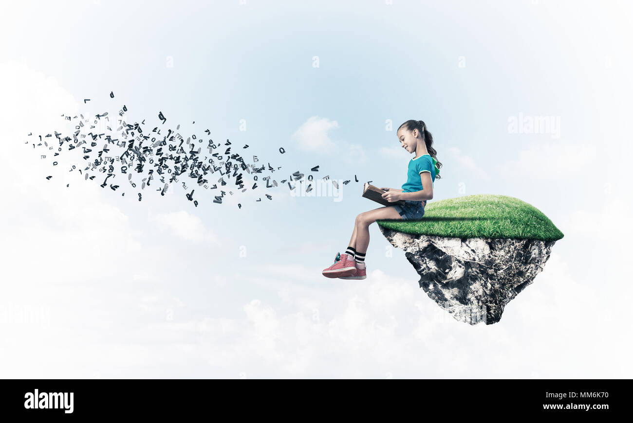 Girl of school age reading book as concept for education Stock Photo ...