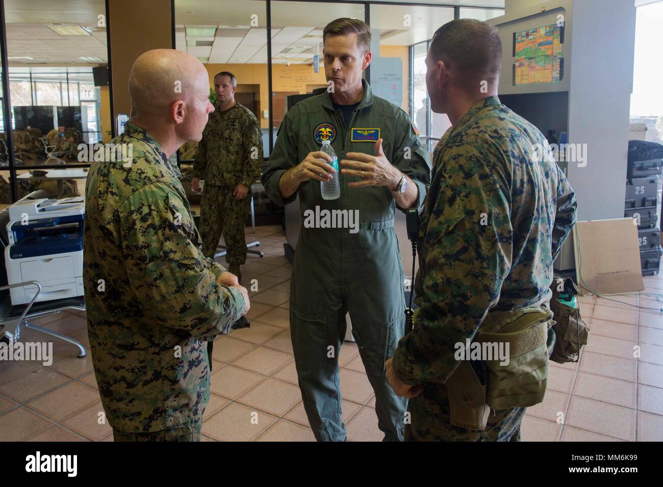 U.S. Navy Rear Admiral Jeff Hughes, center, commander of Expeditionary ...
