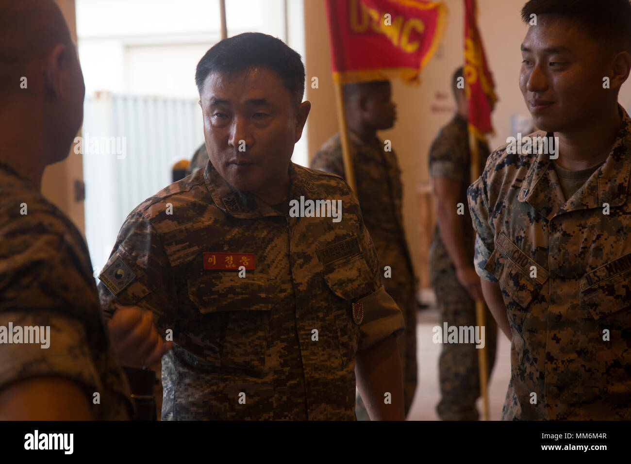 Sgt. Maj. Kyung Woong Lee, left, sergeant major of Republic of Korea Marine Corps, speaks to ...