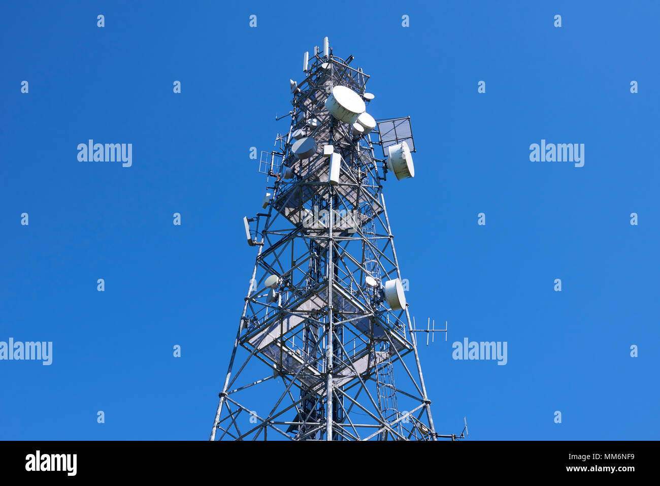 Telecommunication tower with antennas against the blue sky. View from ...