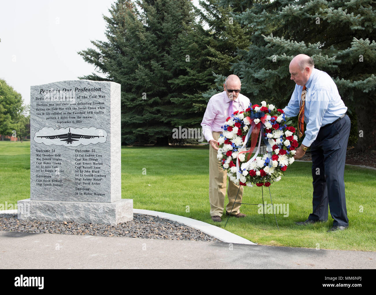 Mr. Larry Frazier (left) and Mr. Greg Staples (right), place a wreath ...