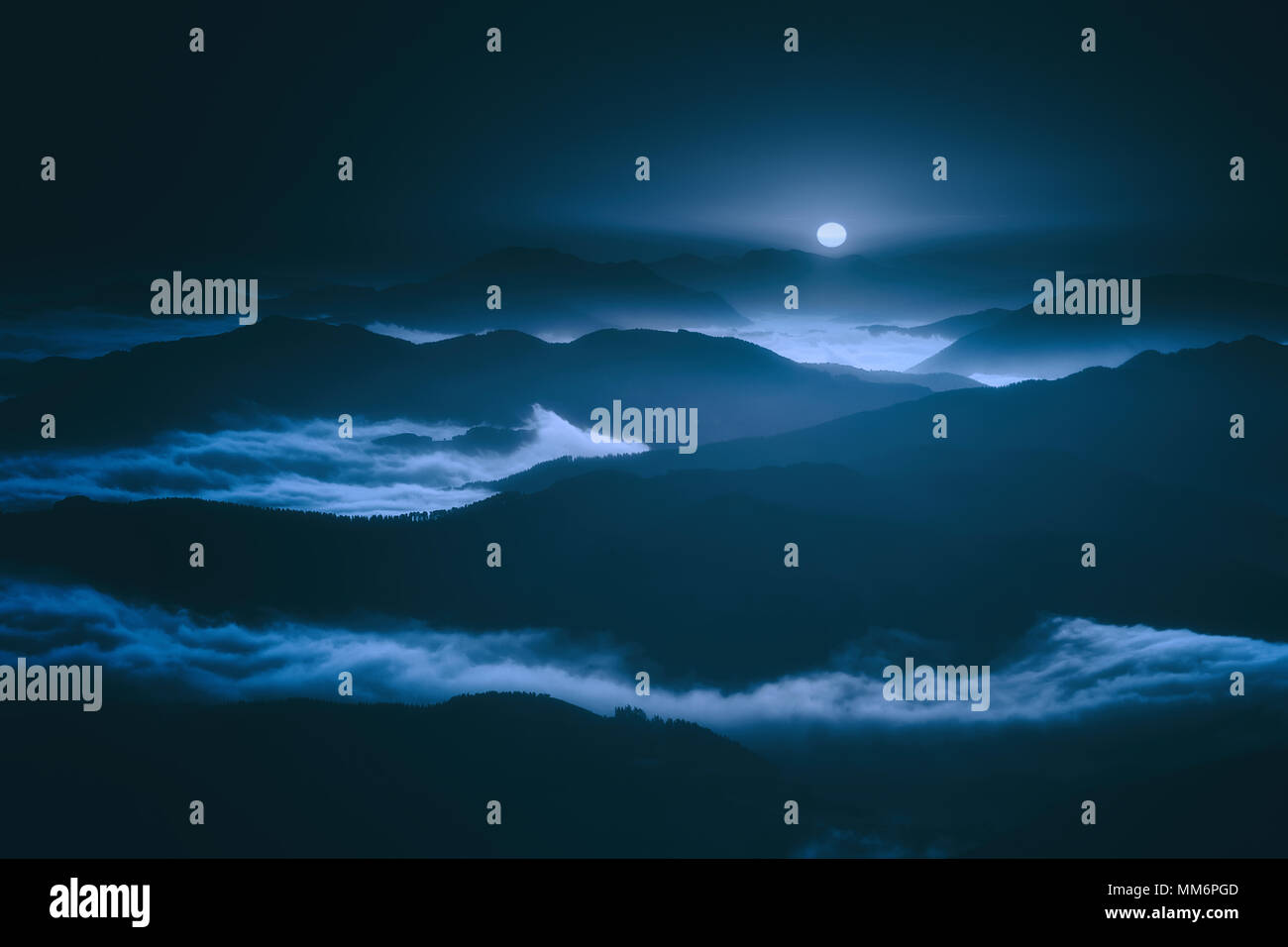 dark landscape with foggy mountains and full moon at night Stock Photo ...