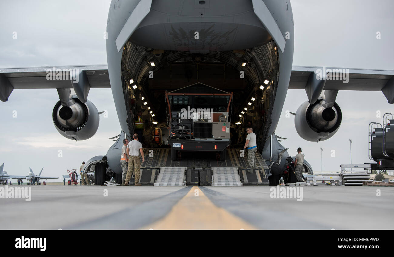 Airmen load a mobile traffic control tower onto a C-17 Globemaster III ...