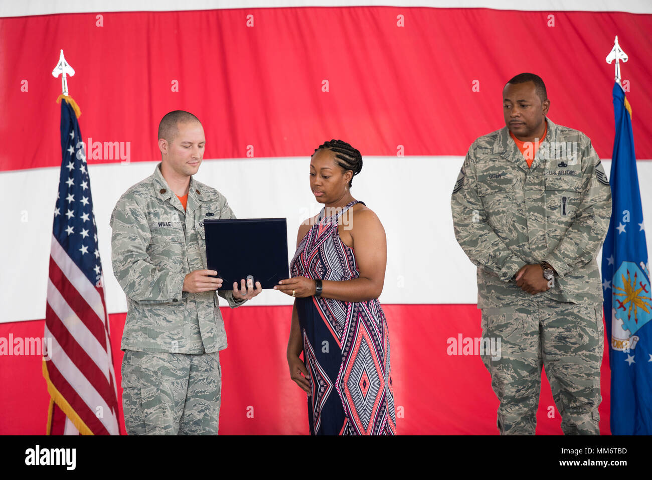 Tiffany Catlin stands with Major Richard Wille, as a letter for her is ...