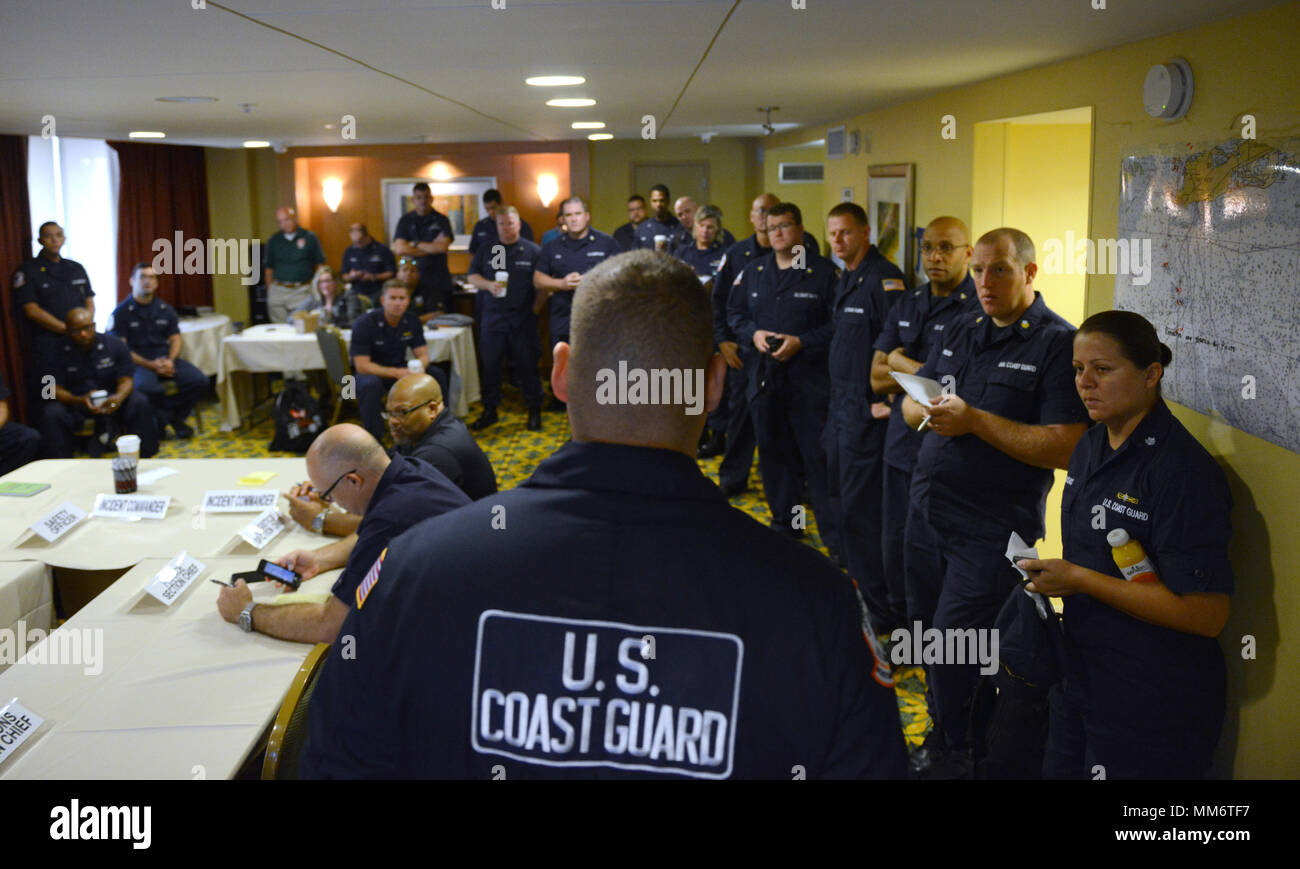 Personnel from various units throughout the Coast Guard listen during a ...
