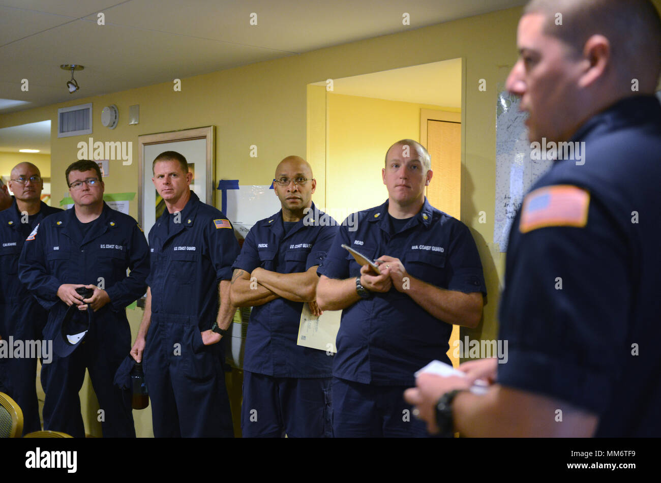 Personnel from various units throughout the Coast Guard listen during a ...