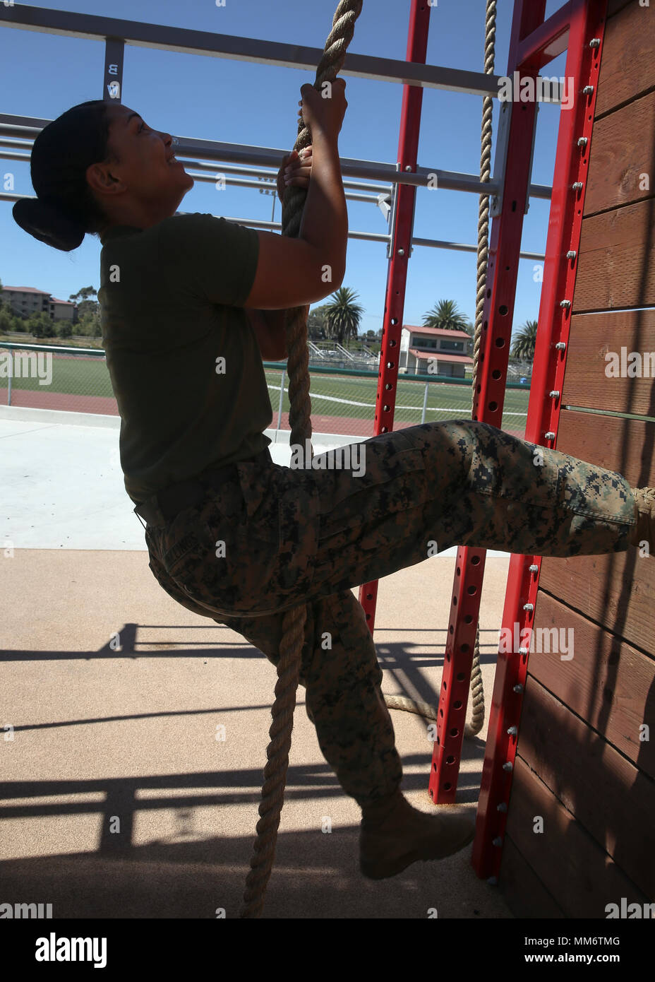 U.S. Marine Corps Lance Cpl. Brittney Hollings climbs a rope while ...