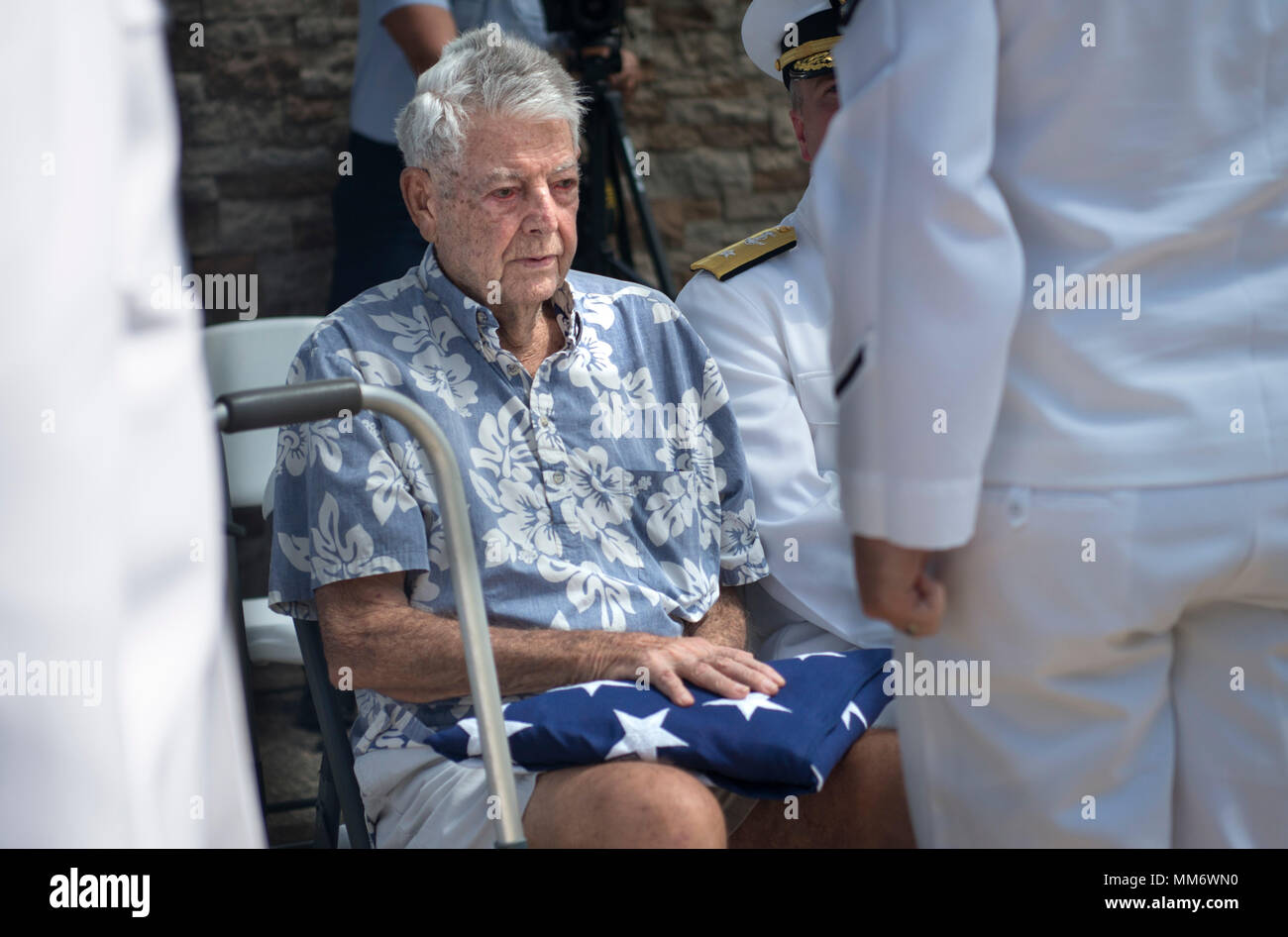 Mr. Ray Emory, a Pearl Harbor survivor, receives the U.S. Flag during ...