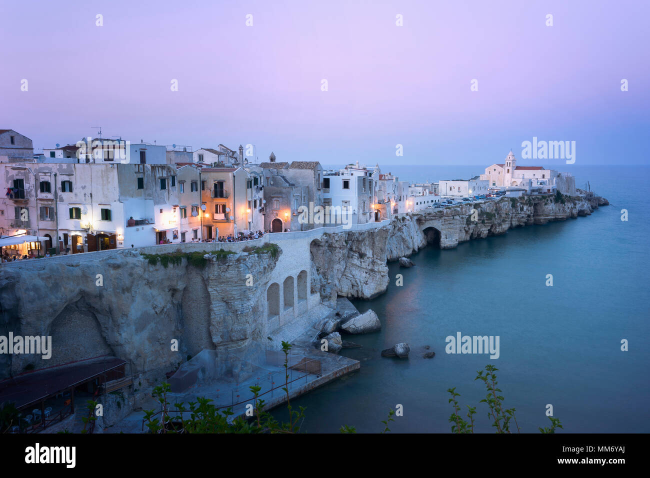 Traditional houses on a cliff on the Mediterranean sea at sunset ...