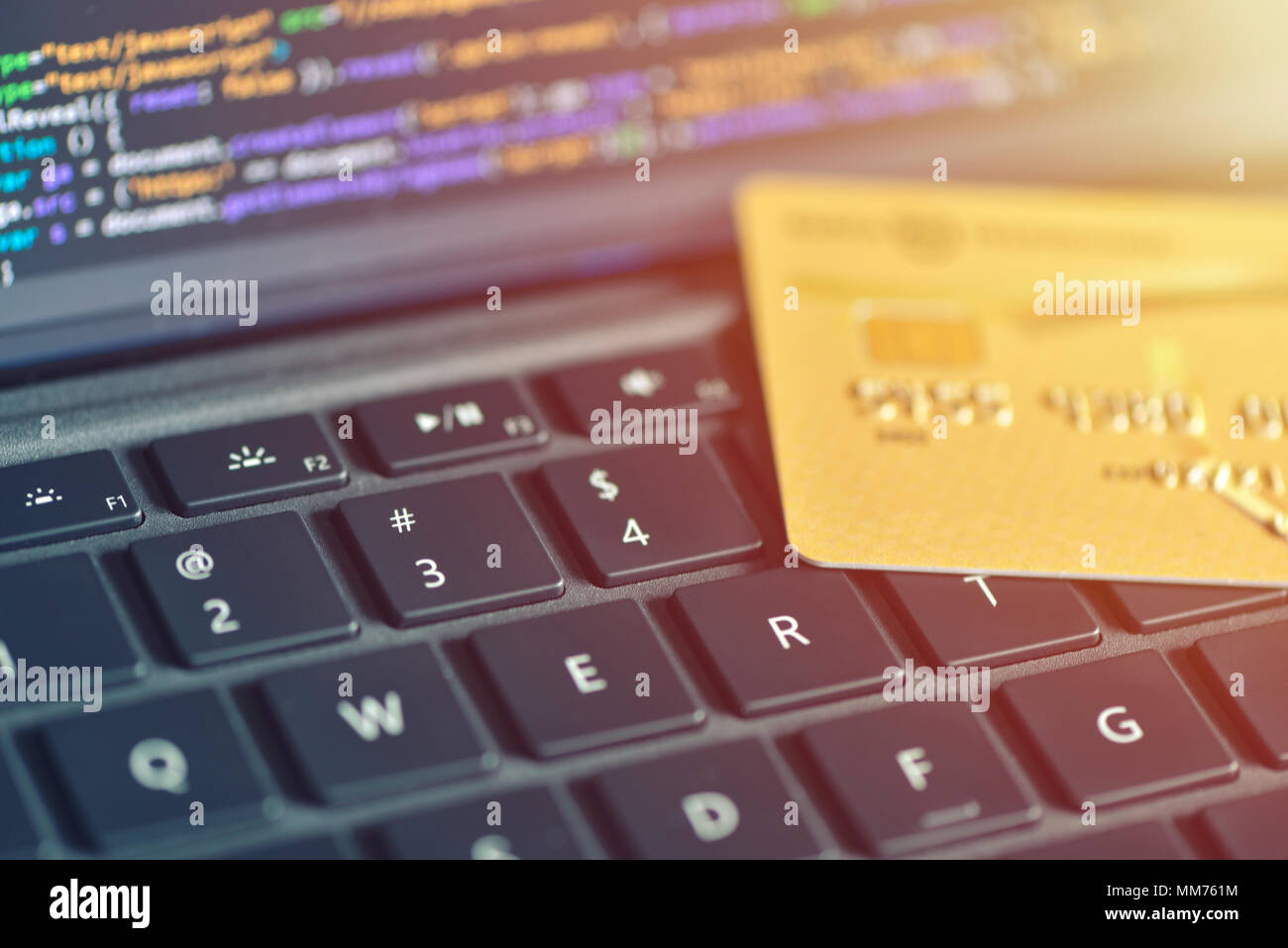 Online payment concept. Credit card on laptop keyboard, close-up angle ...