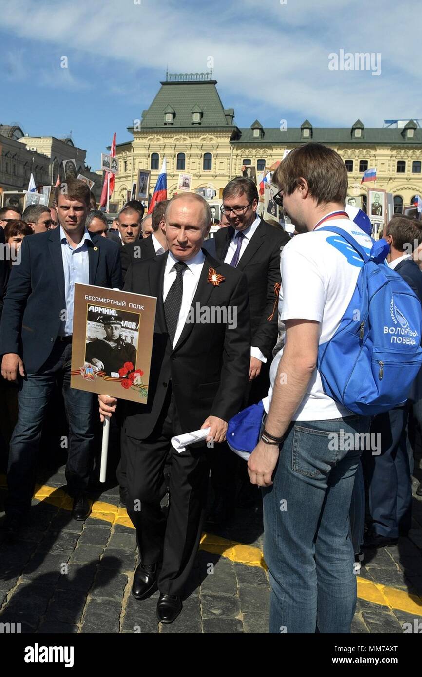 Russian President Vladimir Putin holds a portrait of his father who ...