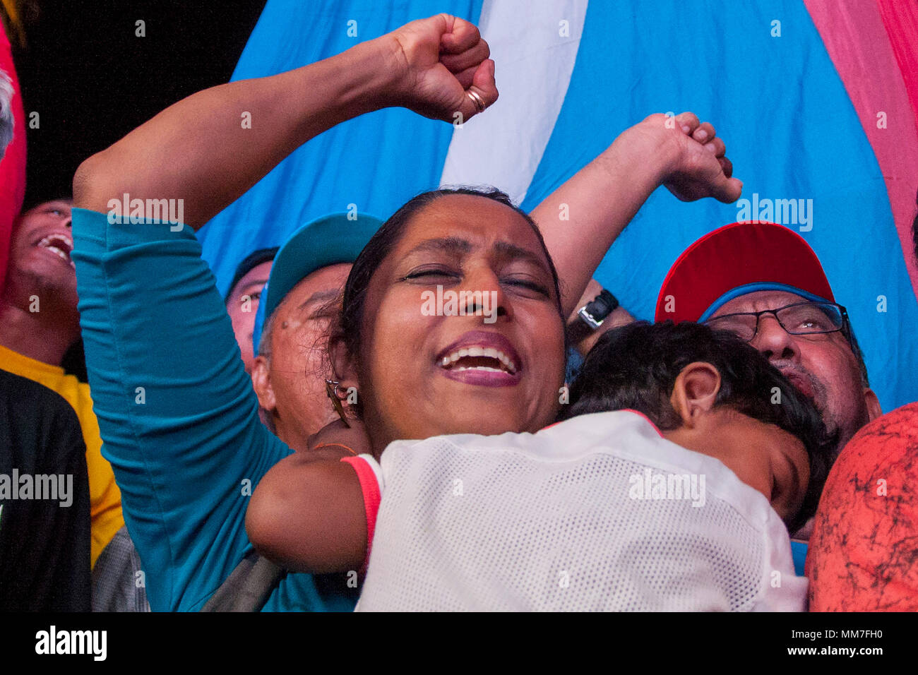 A mother seen cheering while carrying her little child at Padang Timur ...