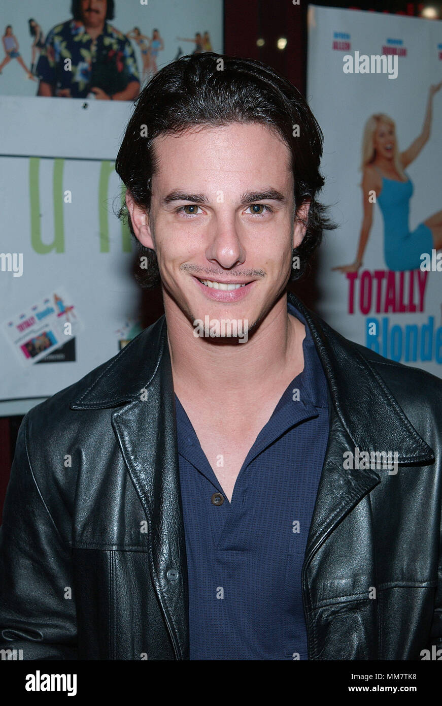 Michael Cade arriving at the premiere of Totally Blonde at the Laemmle ...