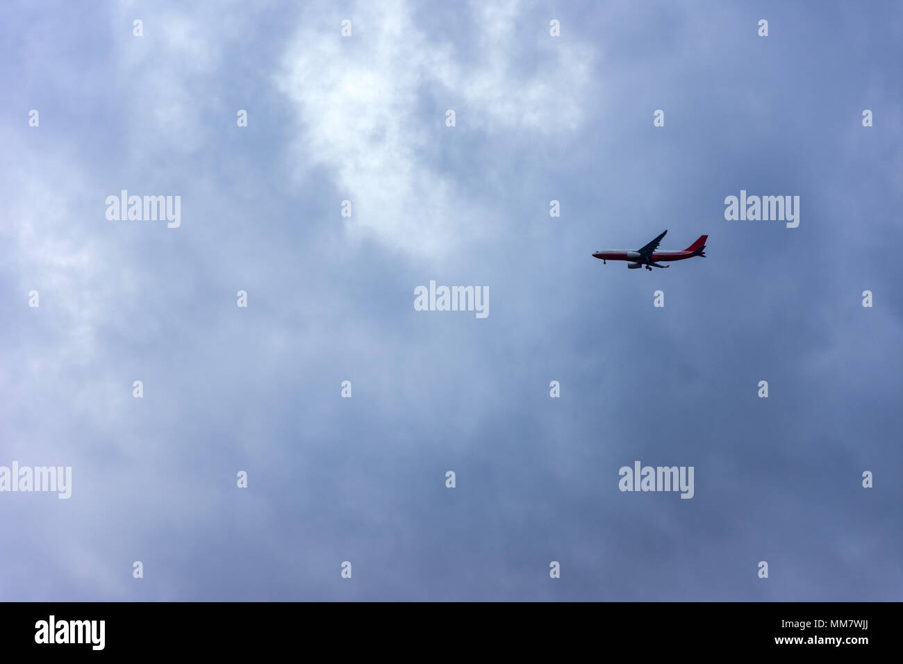 airplane flying in the cloudy and dark sky Stock Photo - Alamy