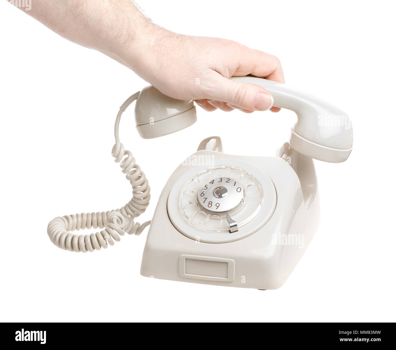 A human holding the reciver of an old Swedish grey telephone with dial ...