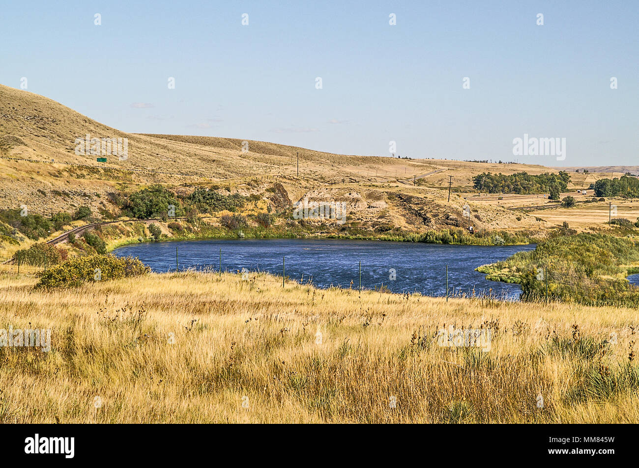Railroad tracks running between an interstate and the Missouri River in ...