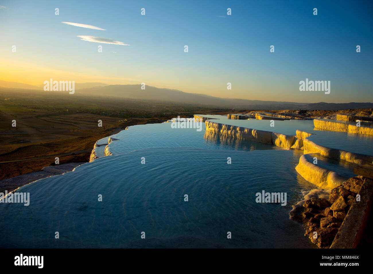 sunset reflecting over the beautiful white stone cascade in the ...