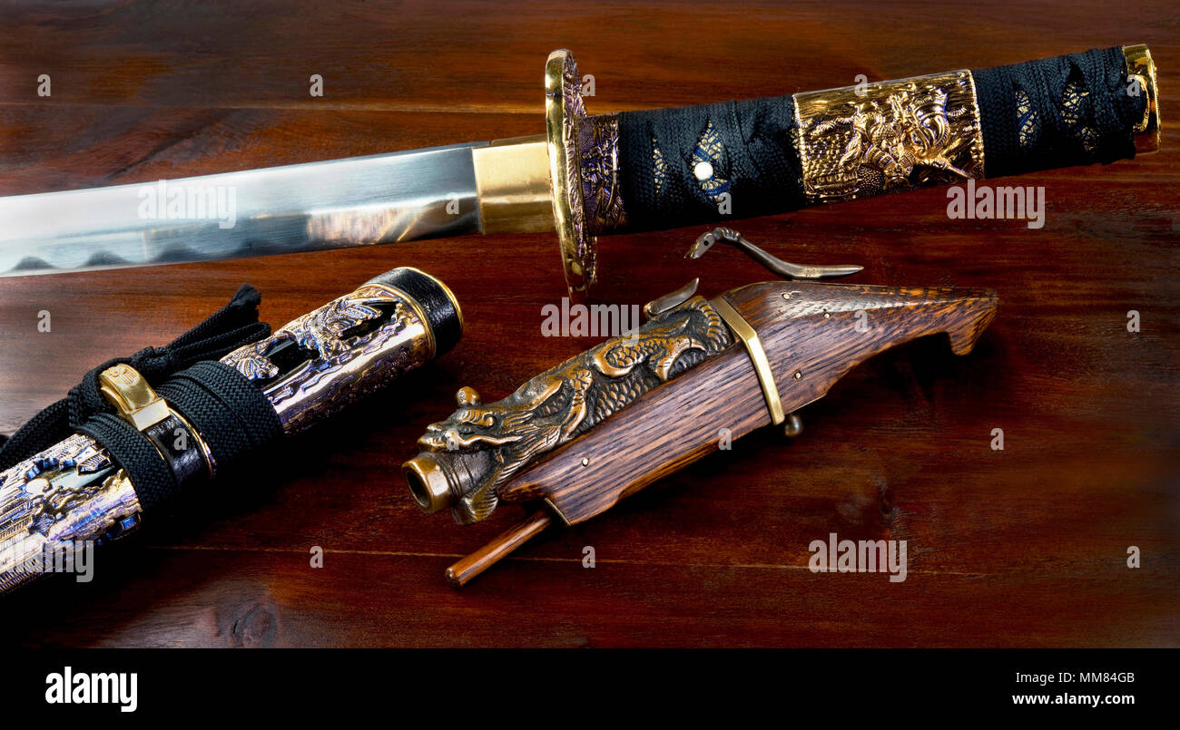 Antique Chinese matchlock pistol and Samurai sword Stock Photo - Alamy
