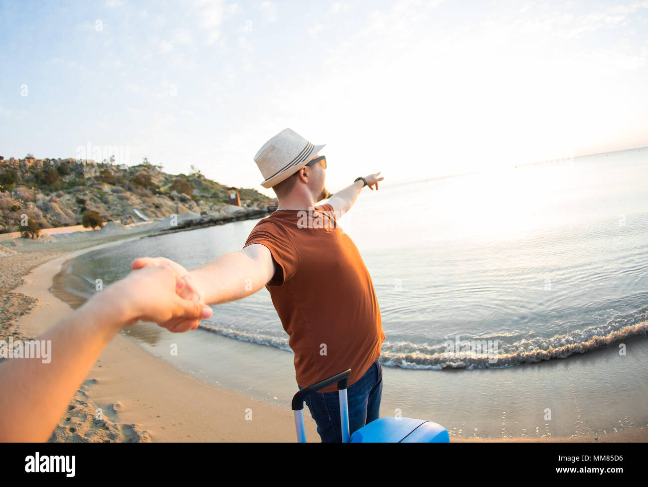 Young man arriving at the resort and standing on the beach Stock Photo ...