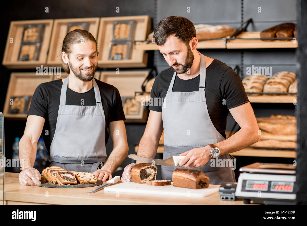 Bread sellers working at the bakery shop Stock Photo - Alamy